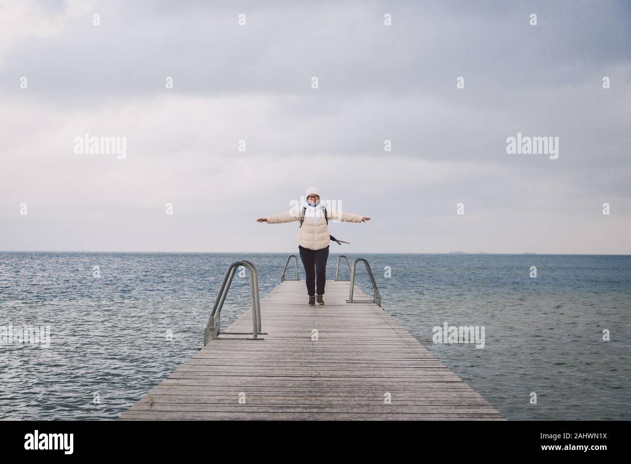 Concept of freedom relaxation. woman relaxing on pier. Woman hiker ...