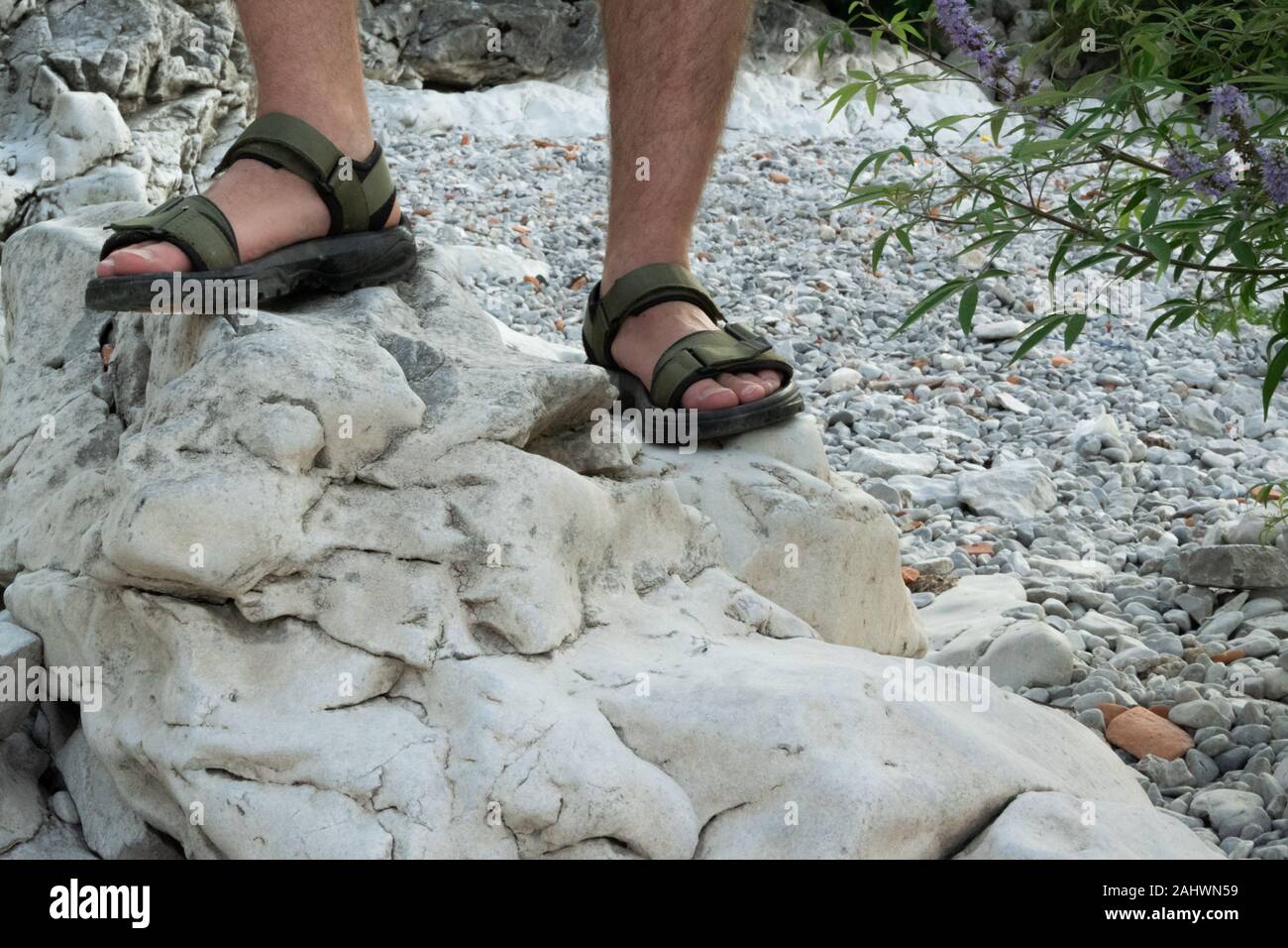 Crop view of man feet on the rock. Adventure traveler concept Stock ...