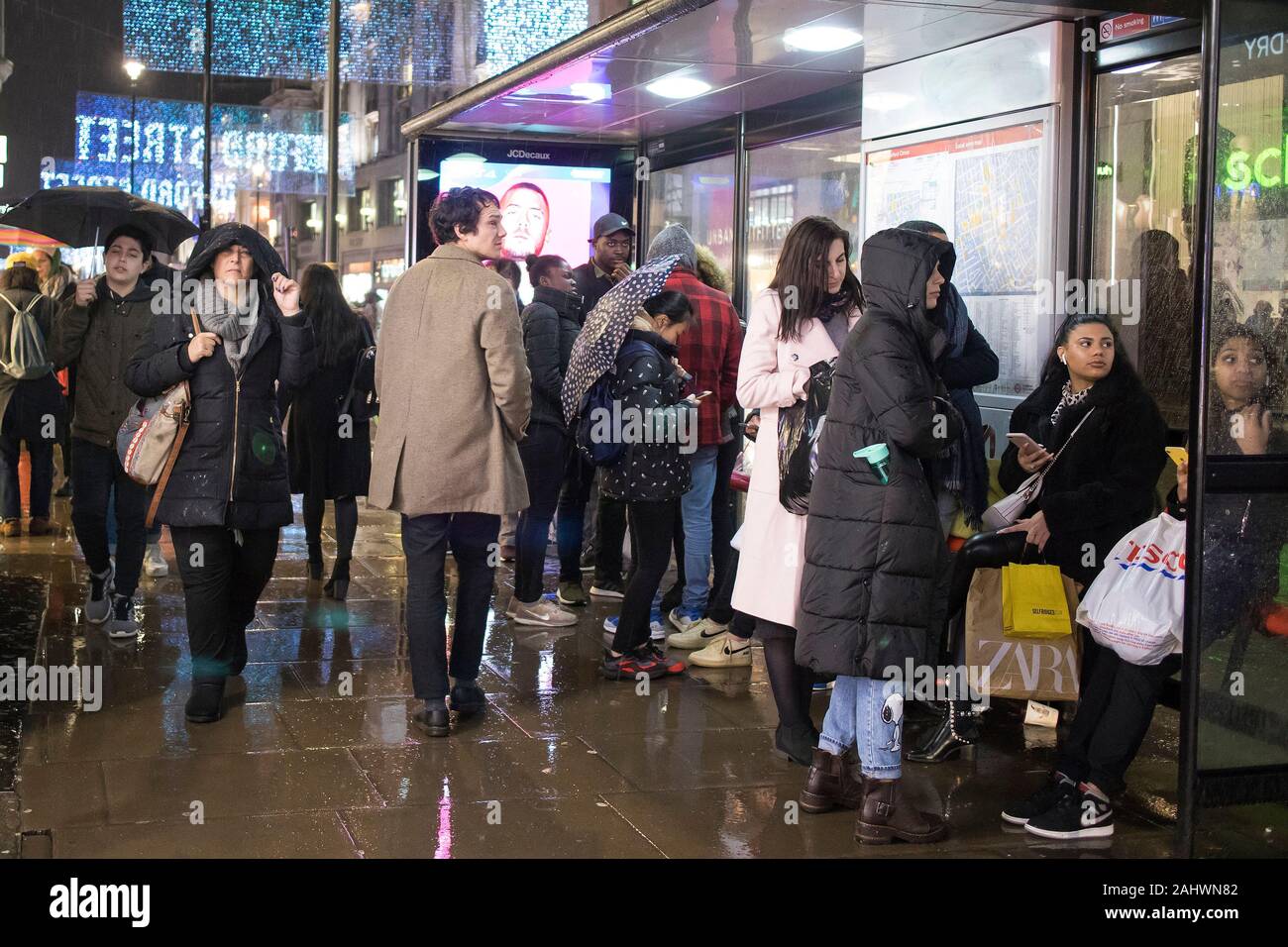 London, UK - 20 December 2019, People waiting for a bus on a crowded ...