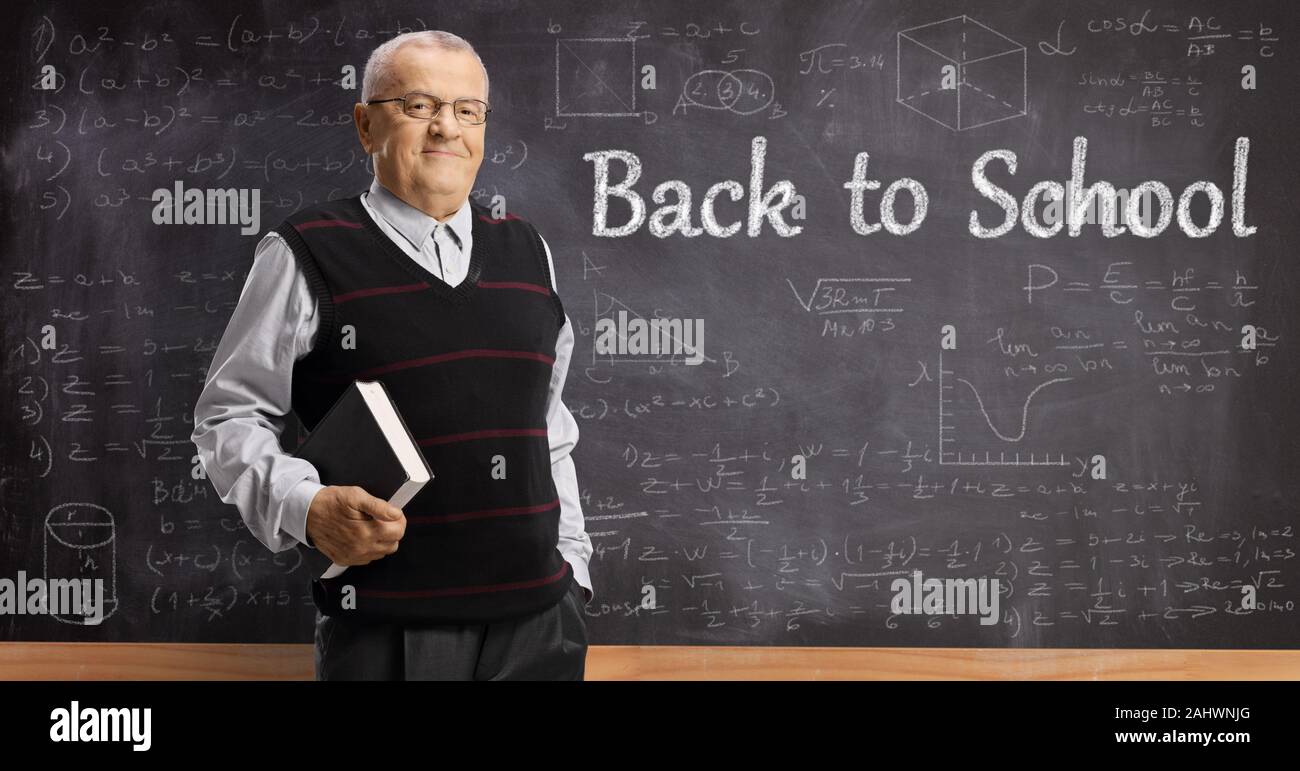 Male professor standing next to a blackboard with text back to school ...