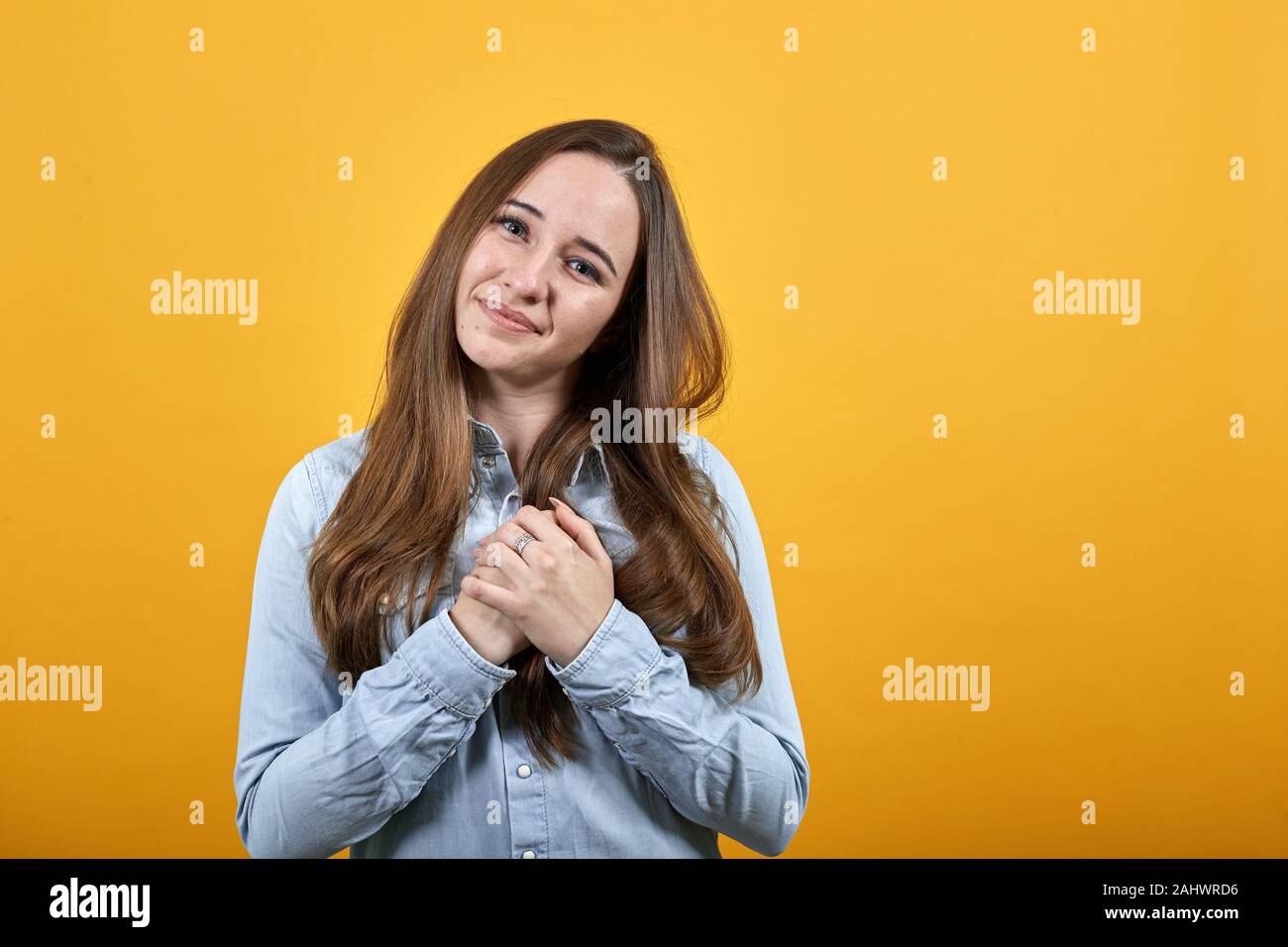 Attractive caucasian woman keeping hands crossed on chest, tilted her ...