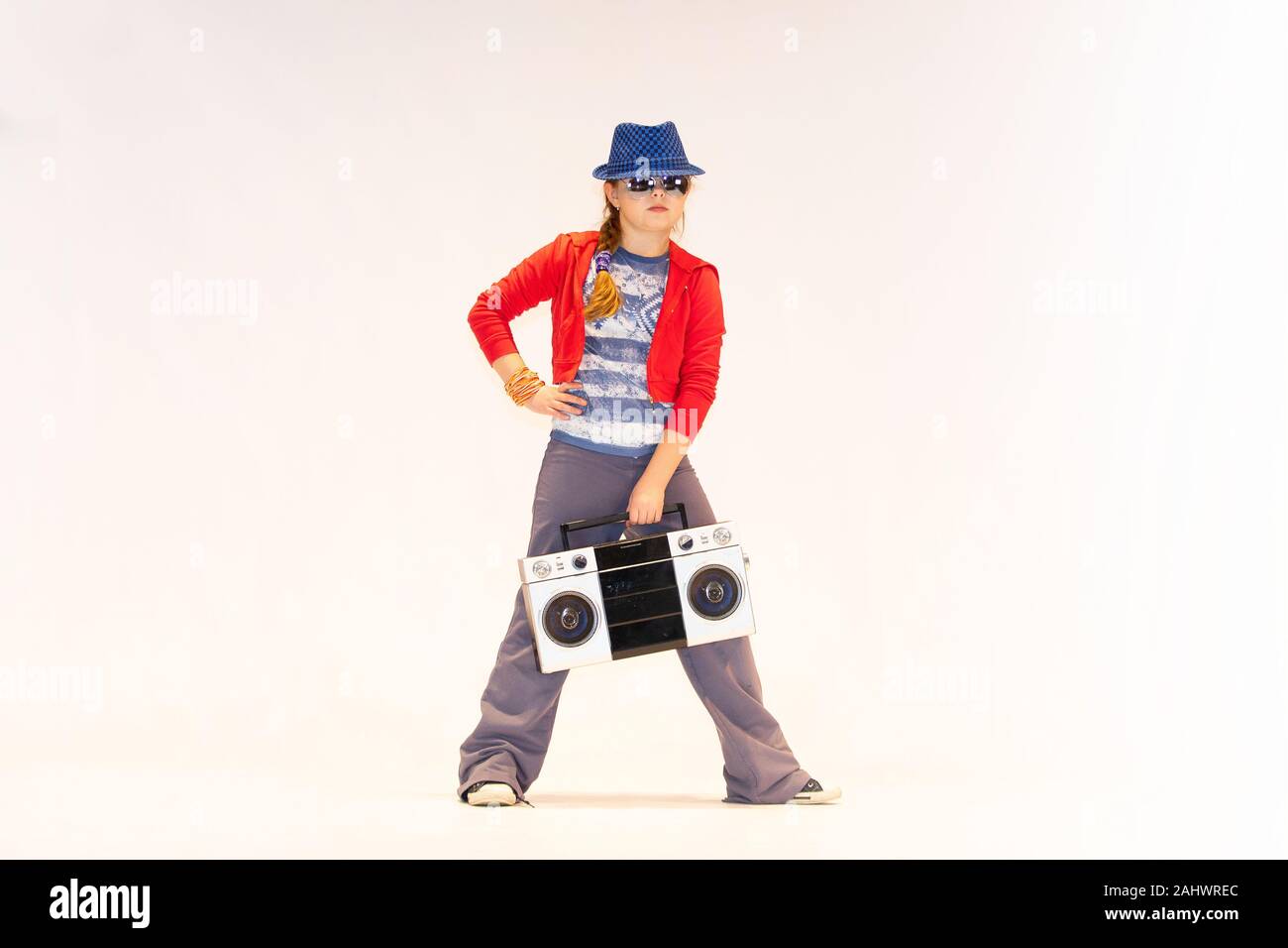 little girl in a hat and glasses with a boombox in his hand Stock Photo ...