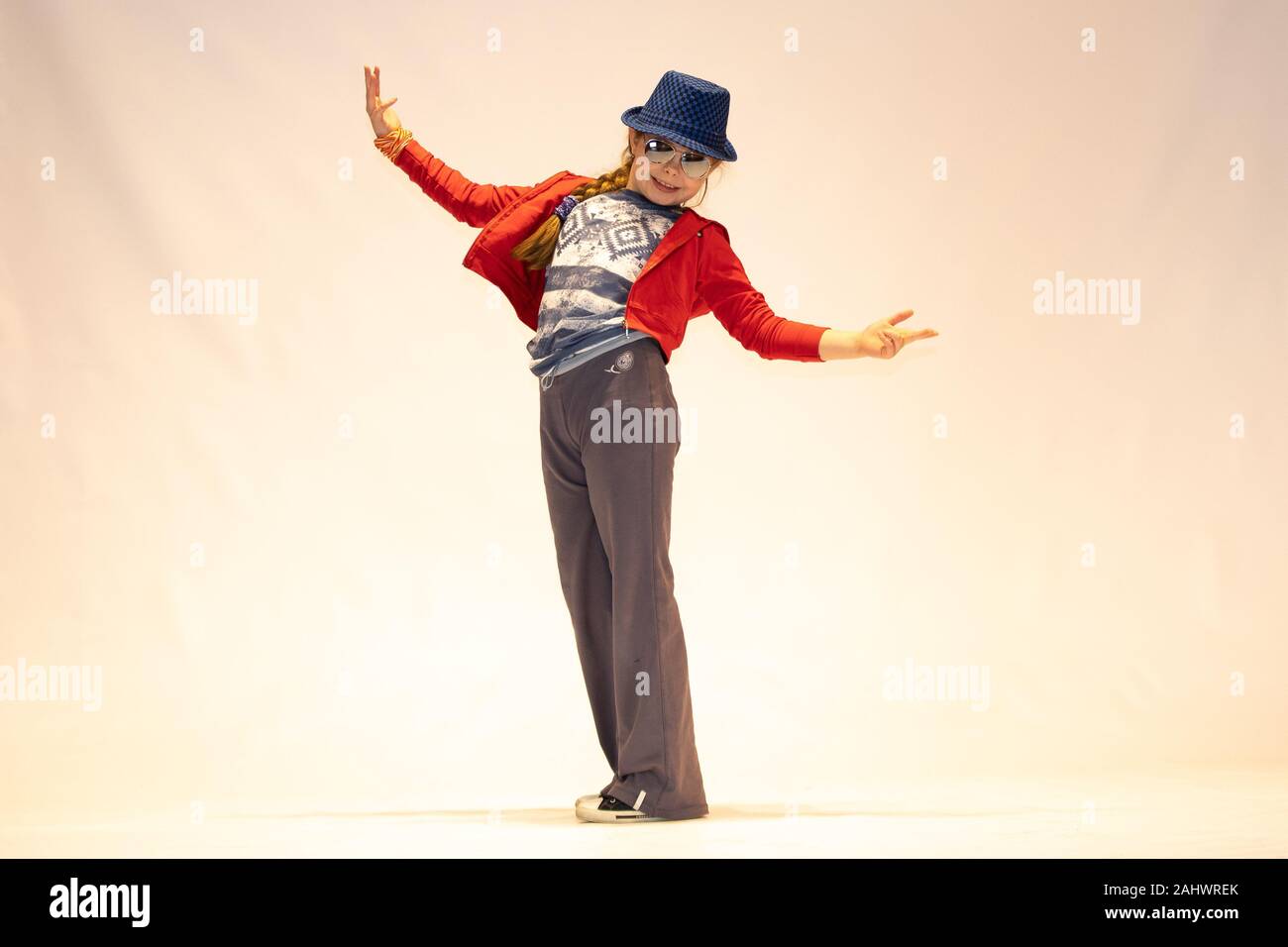 little girl in a cheerful pose Stock Photo - Alamy