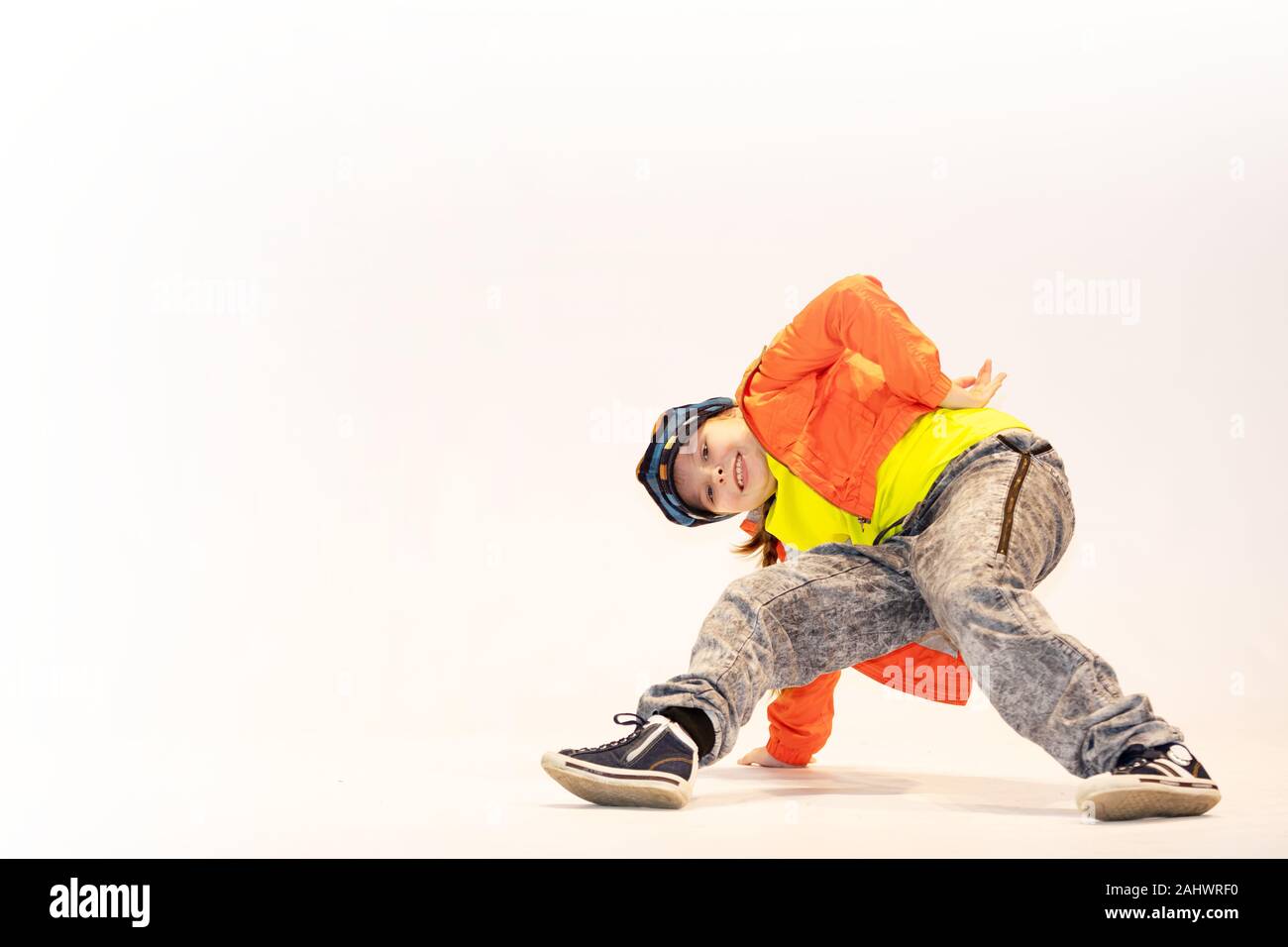 girl in a unique dance position, breakdance kid, a little girl performs ...