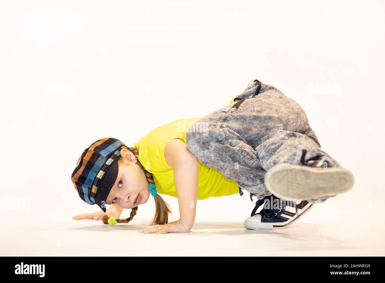 girl in a unique dance position, breakdance kid, a little girl performs ...