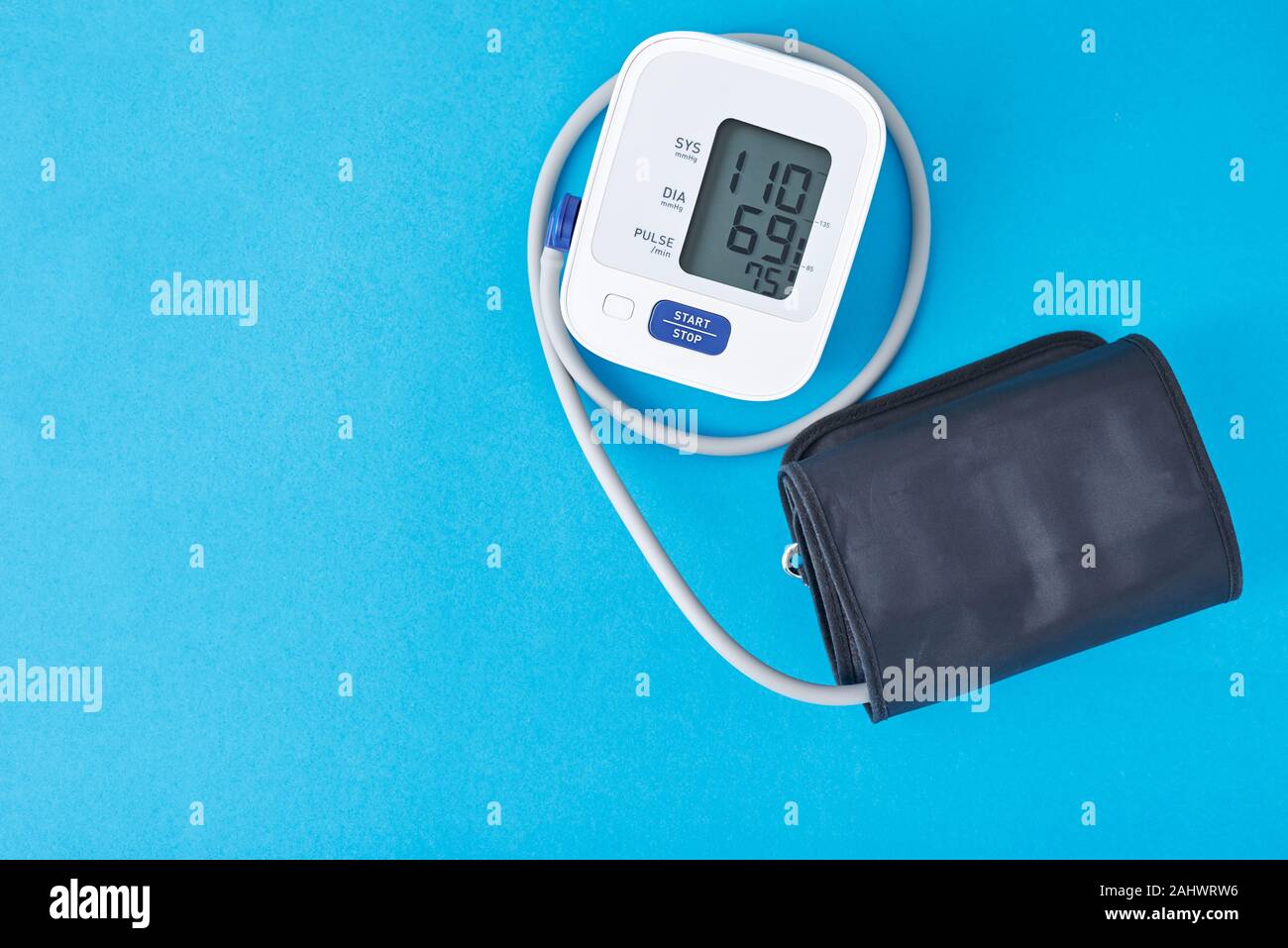 Digital blood pressure monitor on blue background, closeup. Helathcare ...