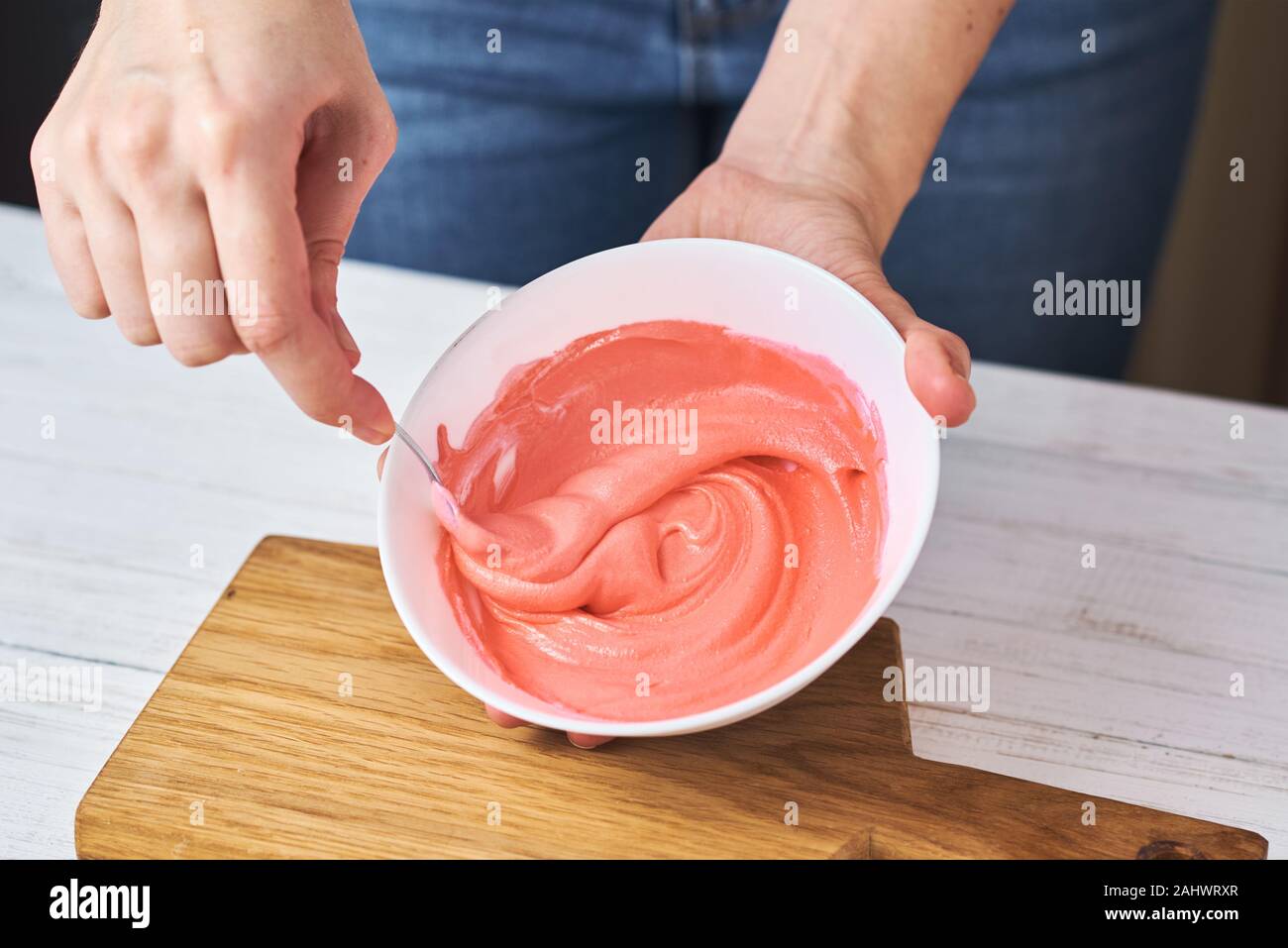 Woman whisking red cream hi-res stock photography and images - Alamy