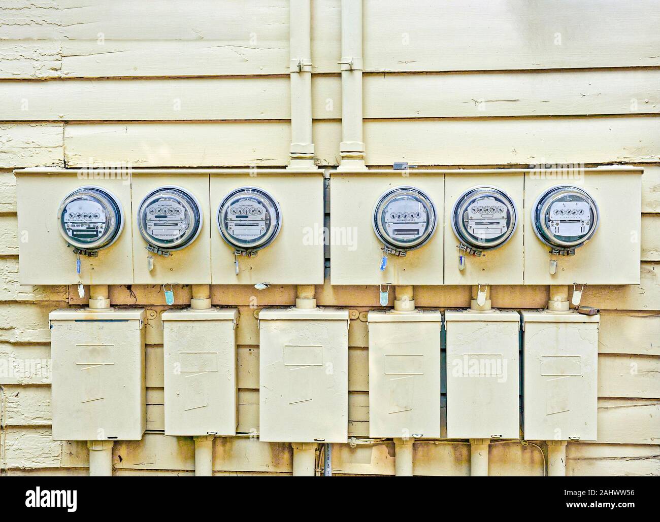 Horizontal shot of electricity meters mounted on the wall of a family ...
