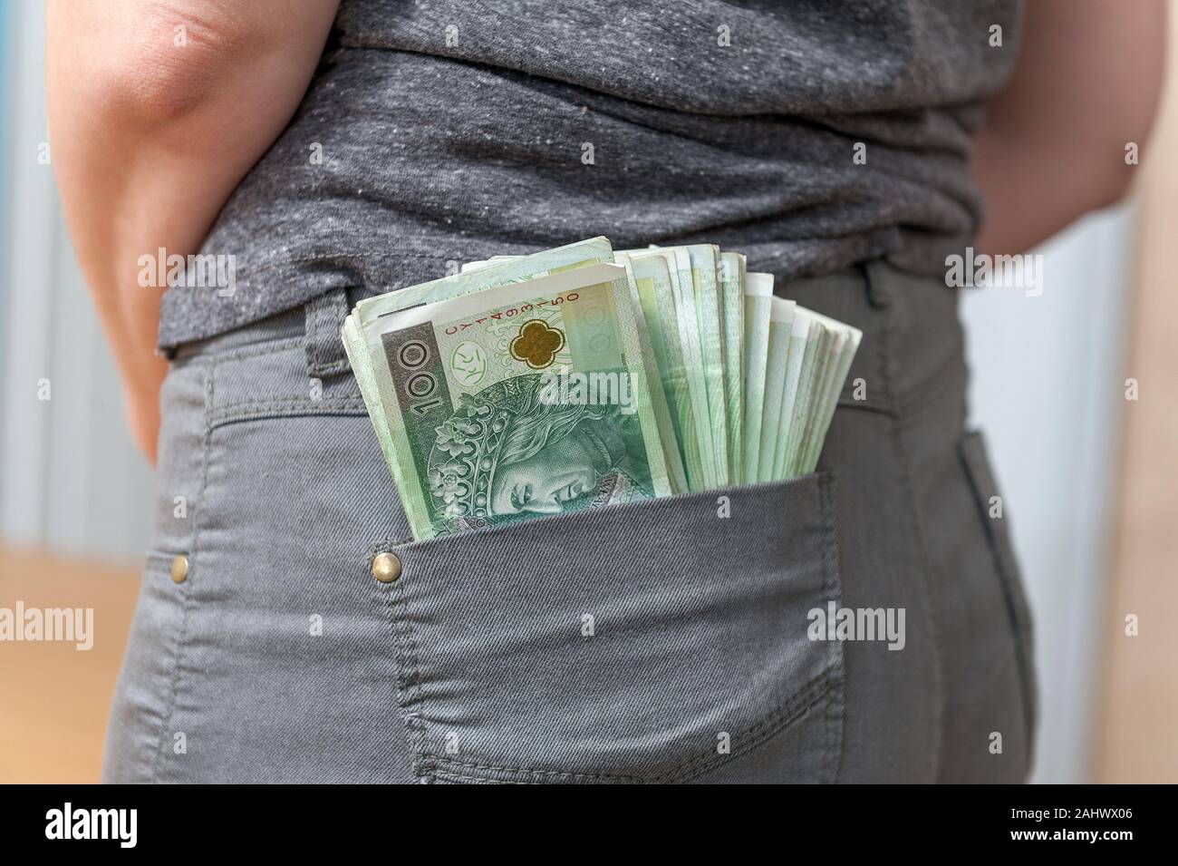 Cash in woman's back pocket. Polish zloty in the pocket. Close up Stock ...