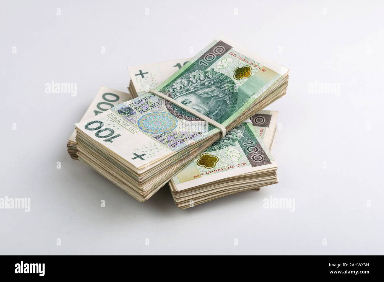Polish money pile. One hundred polish zloty (PLN) banknotes on white ...