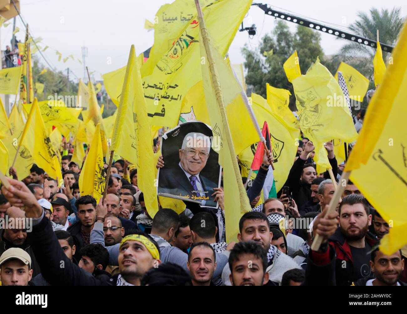 Palestinians waving yellow Fatah flags during a rally marking the 55th ...