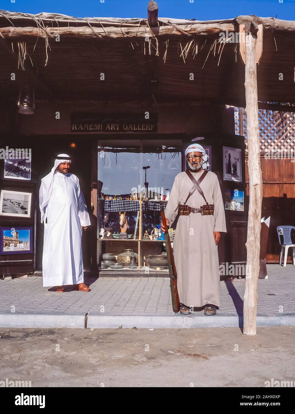 Dubai Arab folklore and history with a couple of Emirati men taking a ...