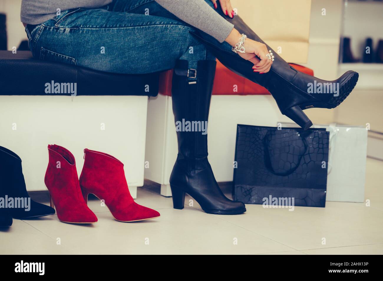 Woman Putting On Boots High Resolution Stock Photography and Images - Alamy