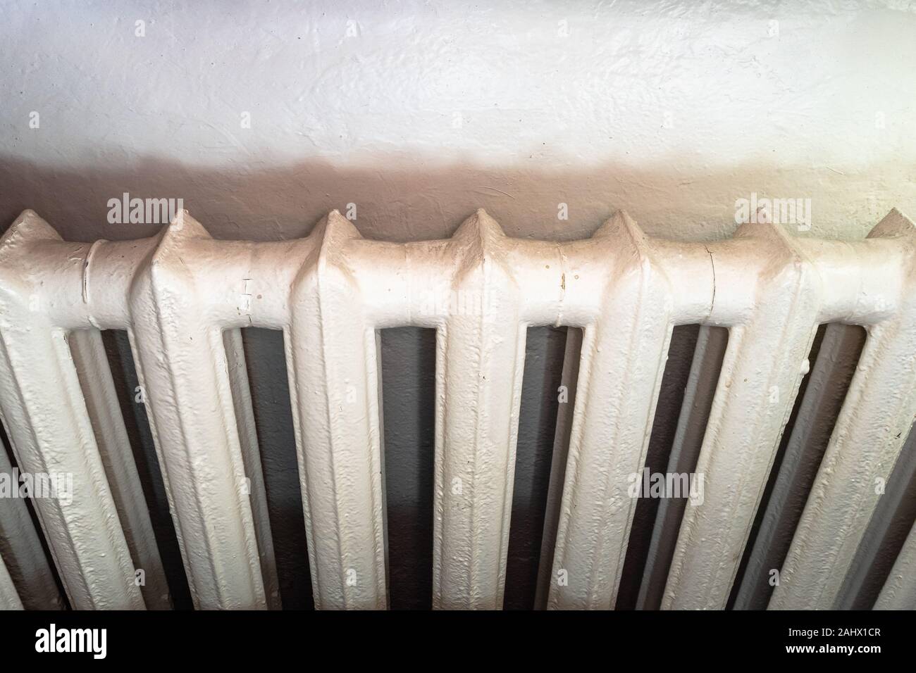 white painted old cast iron heating radiators in country house Stock ...