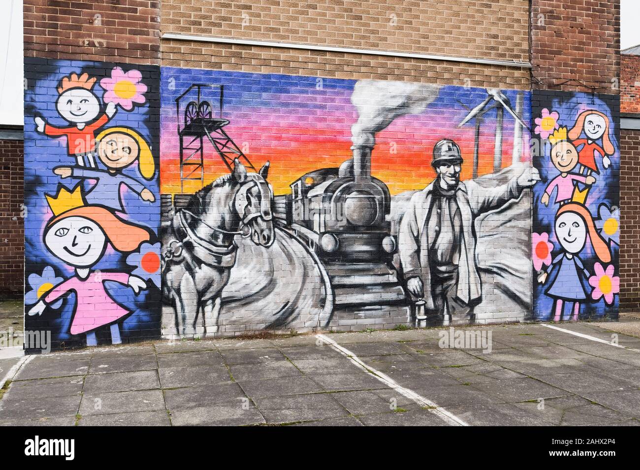 Ellington, Northumberland, UK. A mural depicts mining heritage in the ...