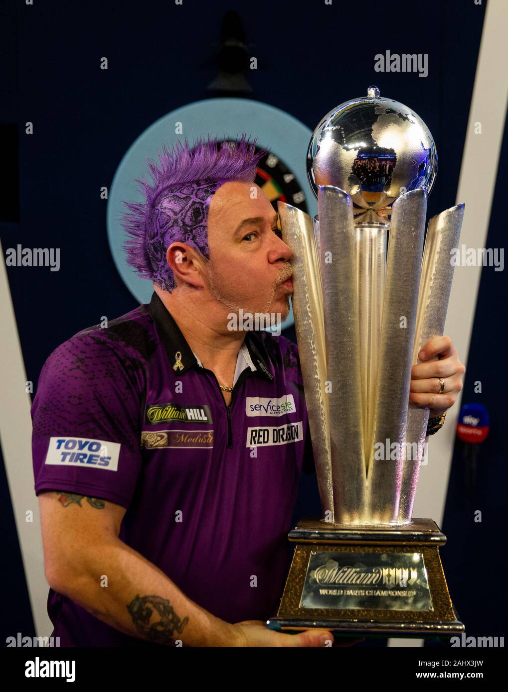 Peter Wright celebrates winning with the Sid Waddell trophy during day ...