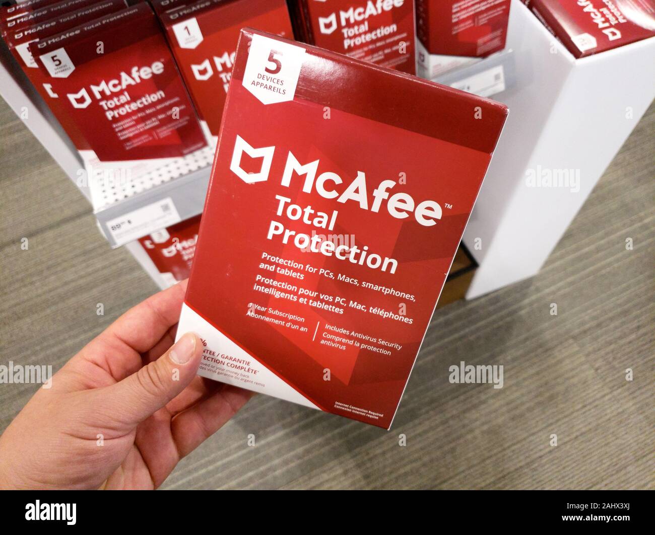 Montreal, Canada - December 26, 2019: A hand holding McAfee Total ...