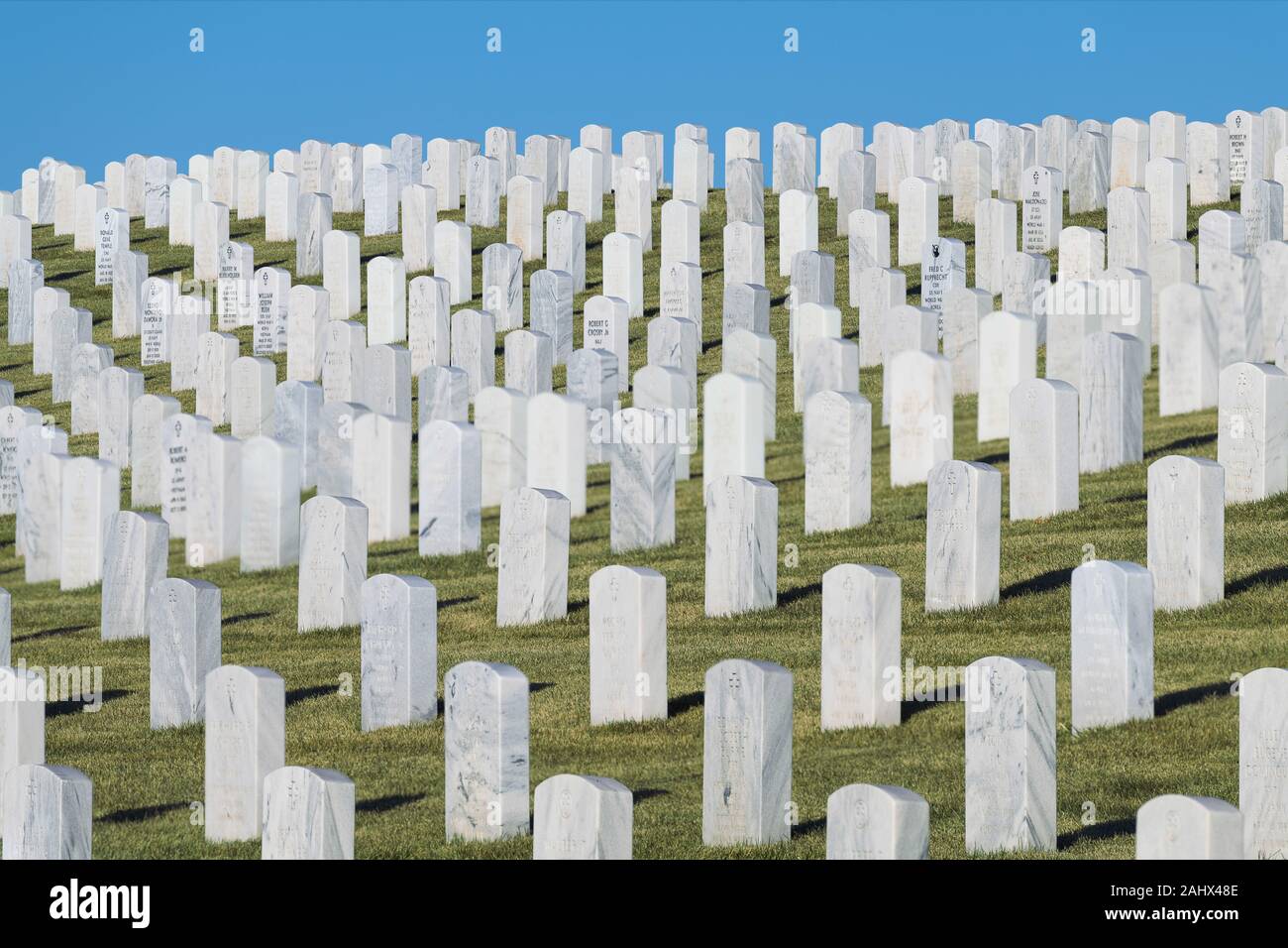 Gravestones line the green hills of the historic Santa Fe National ...