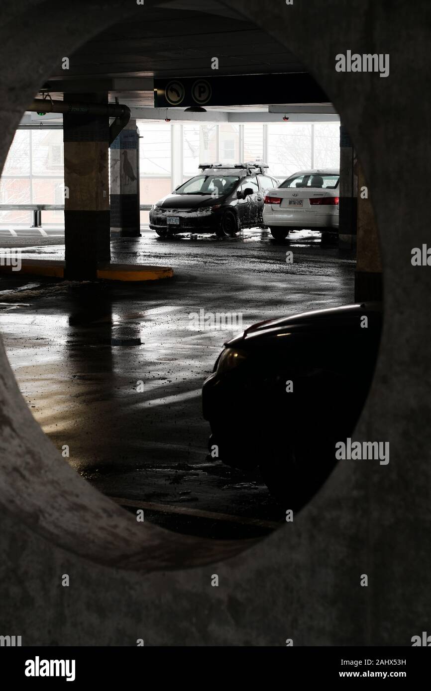 Interior shot of cars parked in a multi-story parking garage, as seen ...