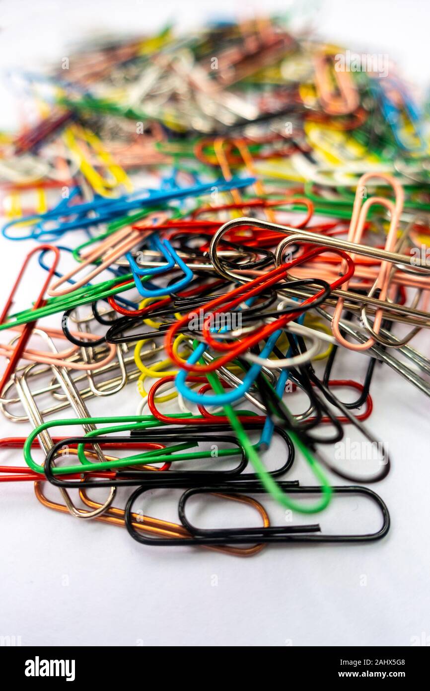 A pile of paper clips against a white background Stock Photo - Alamy