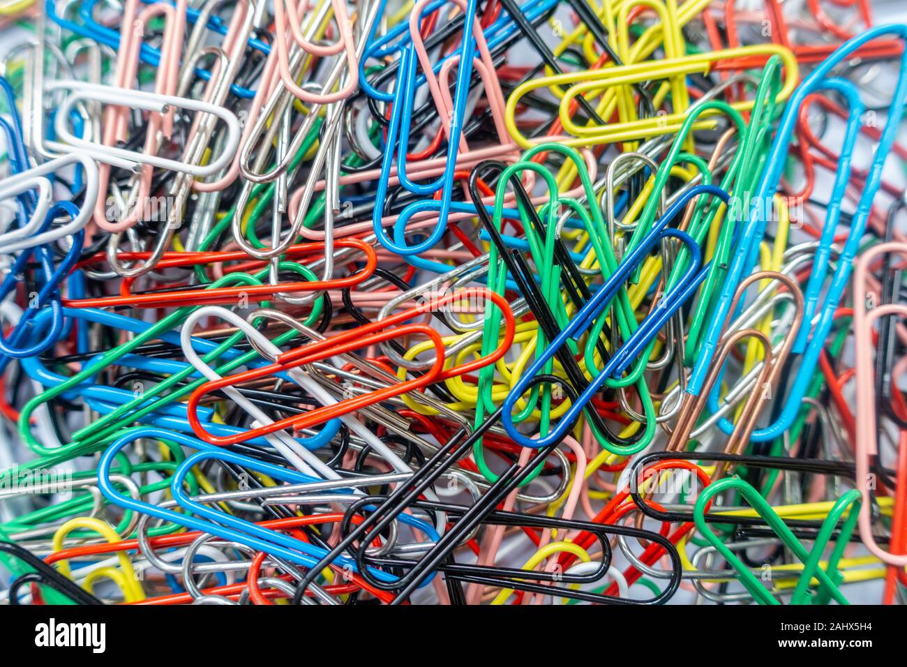 A pile of paper clips against a white background Stock Photo - Alamy