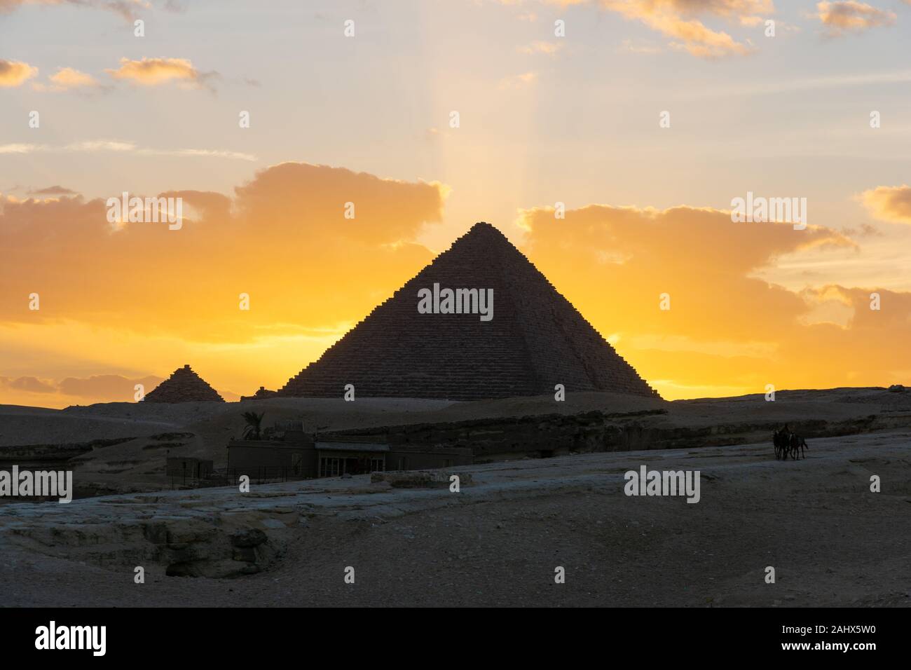 Sunset in Giza pyramid complex. The Sun is going down behind the ...