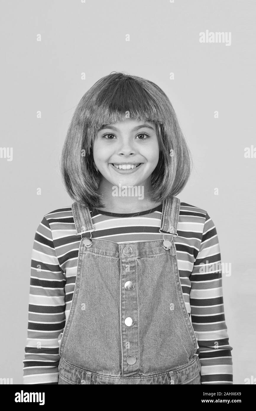 Being fancy child. Small child wear violet hair wig yellow background ...