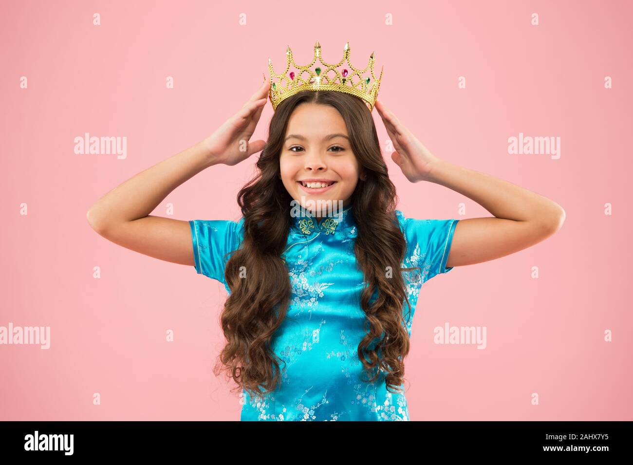 pageant queen. happy kid chinese dress wear crown. portrait of pride ...