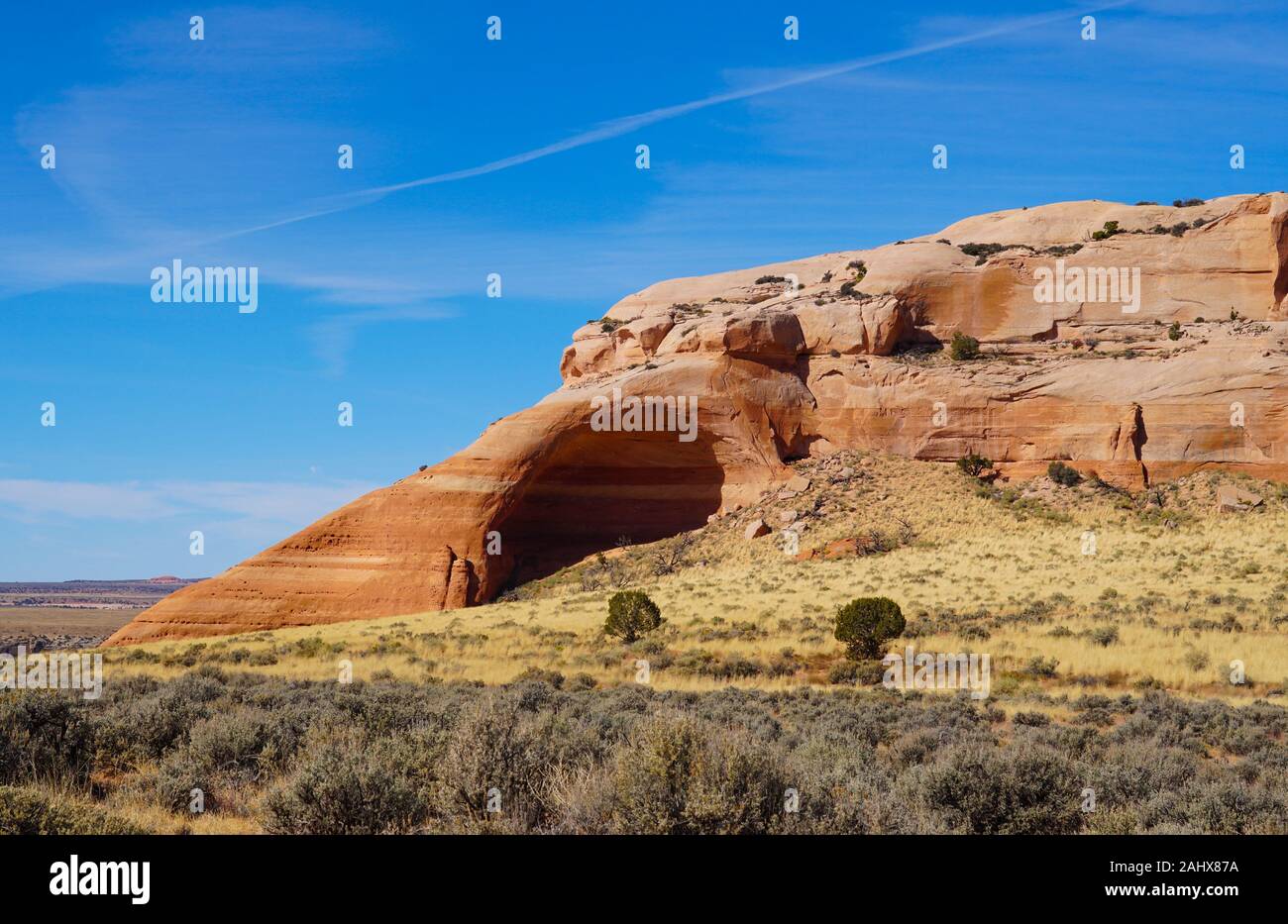A natural rounded cave shows the beauty of the sandstone's colors and ...