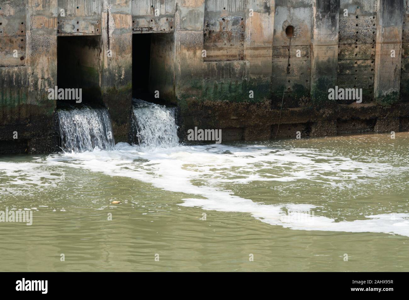 dirty water flow to sewer from city, waste water flows from a pipe ...