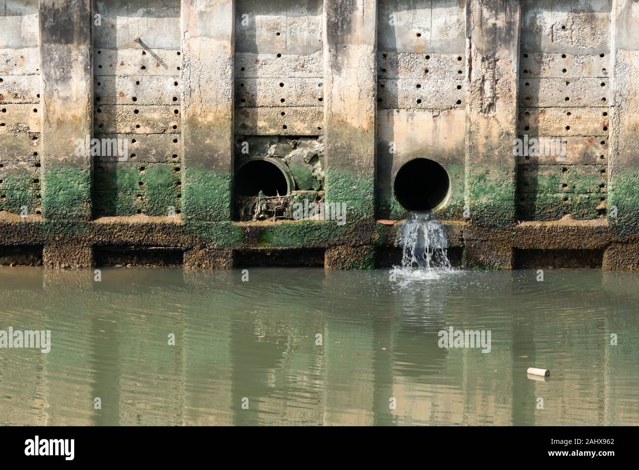 waste water flow to sewer from city,Dirty water flows from a pipe ...