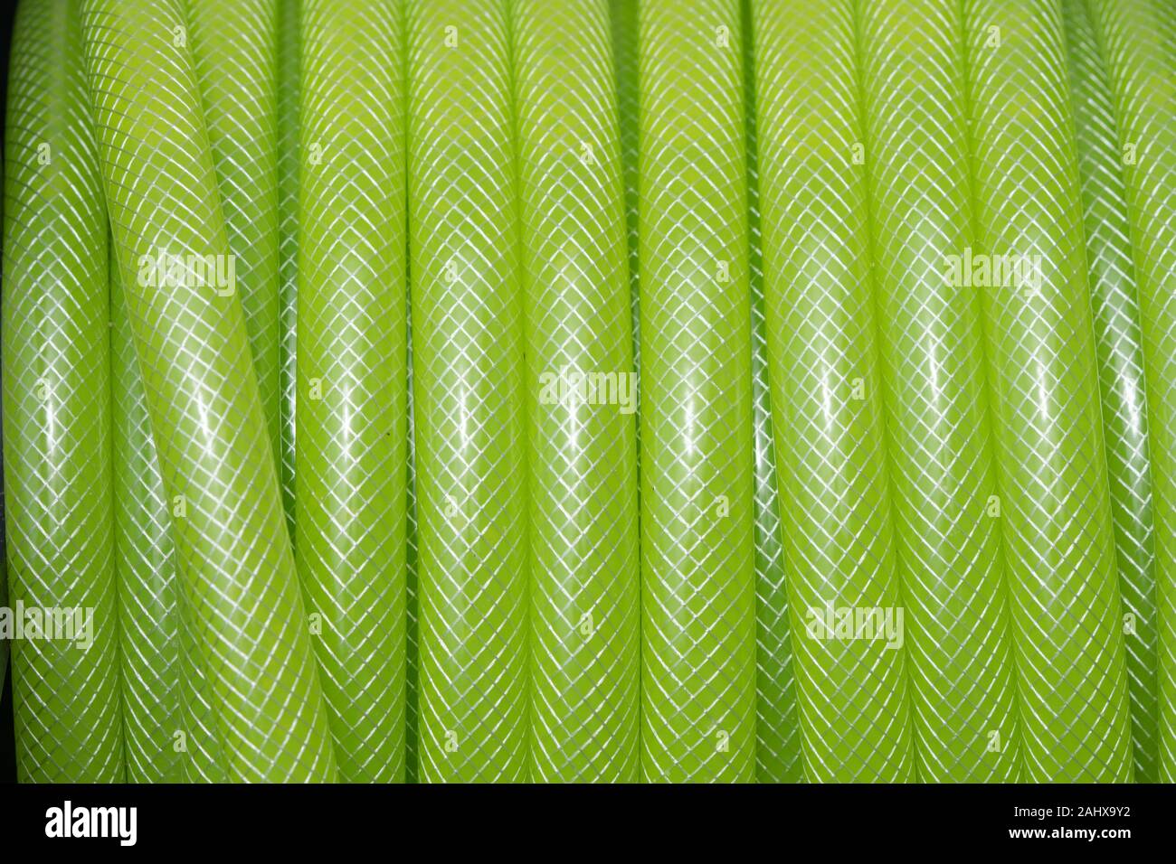 Green plastic rubber strap water for plants Stock Photo - Alamy