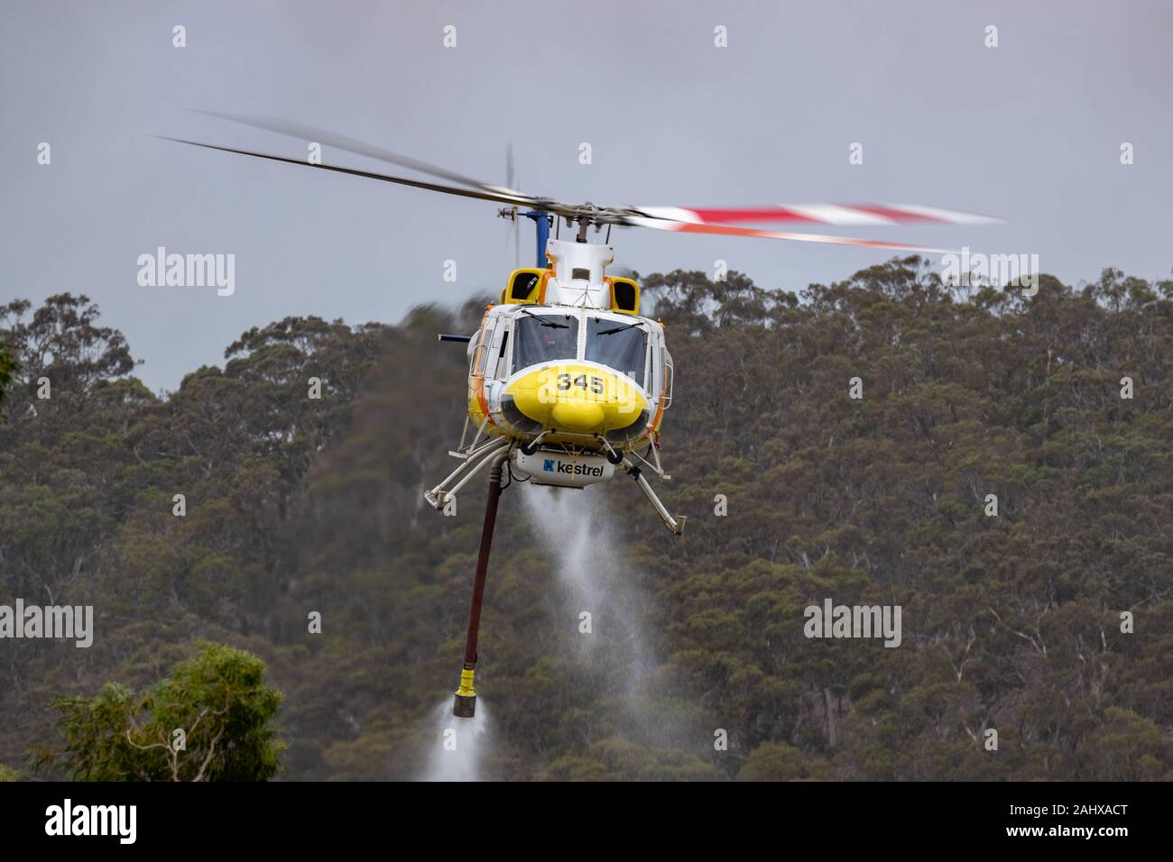 Bell 412 helicopter taking off after filling with a load of water to ...