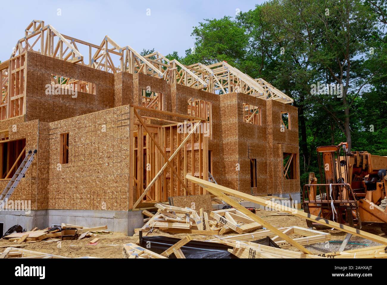 Framing beam of new house boom truck forklift in the under construction ...