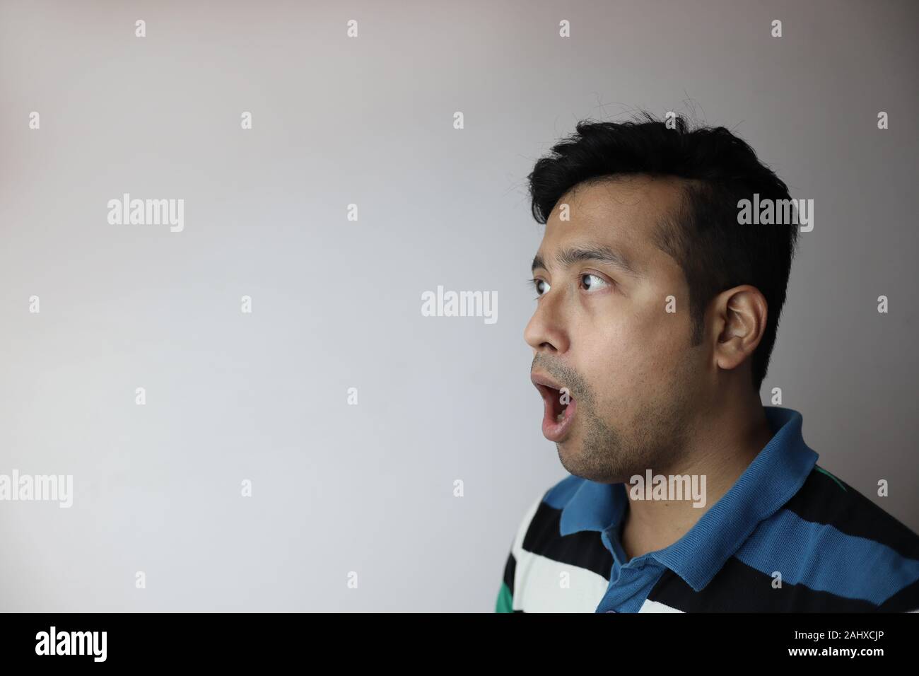 omg . left side face of an asian man with amazed expression looking ...