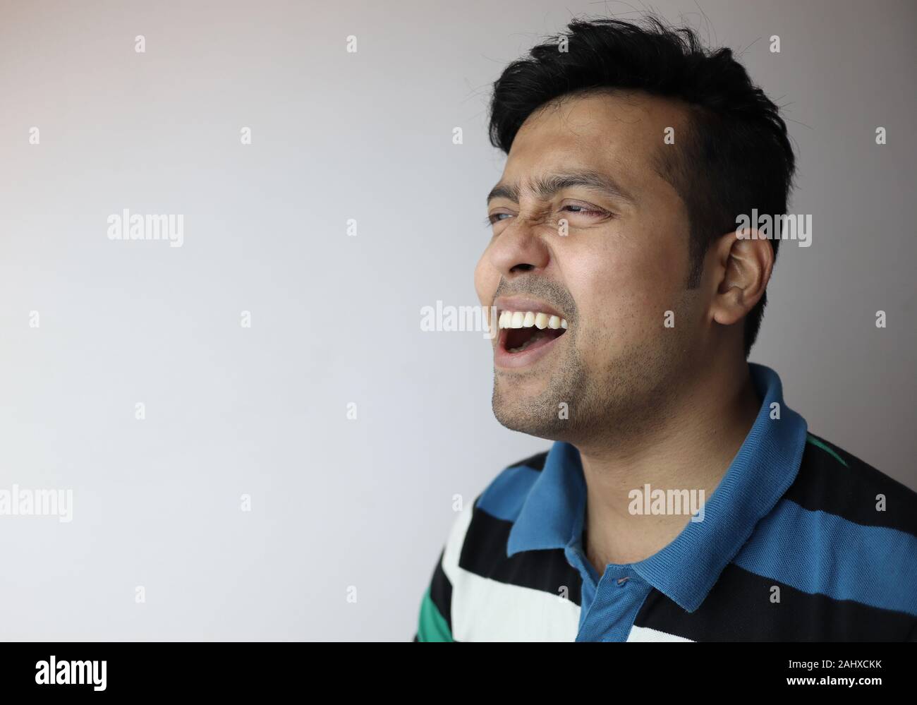 What. left side face of an asian man with funny irritated expression ...