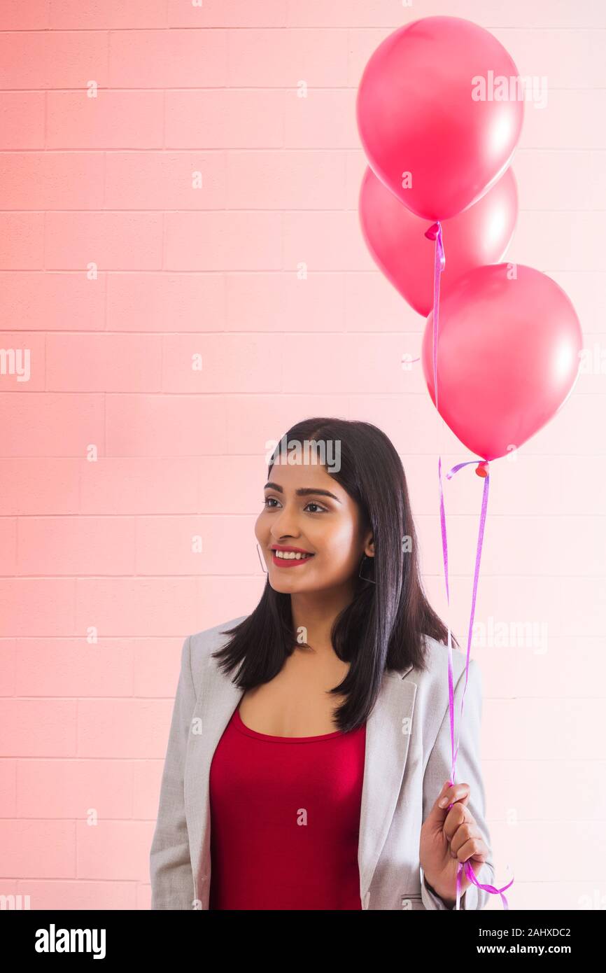 Balloons in hand hi-res stock photography and images - Alamy