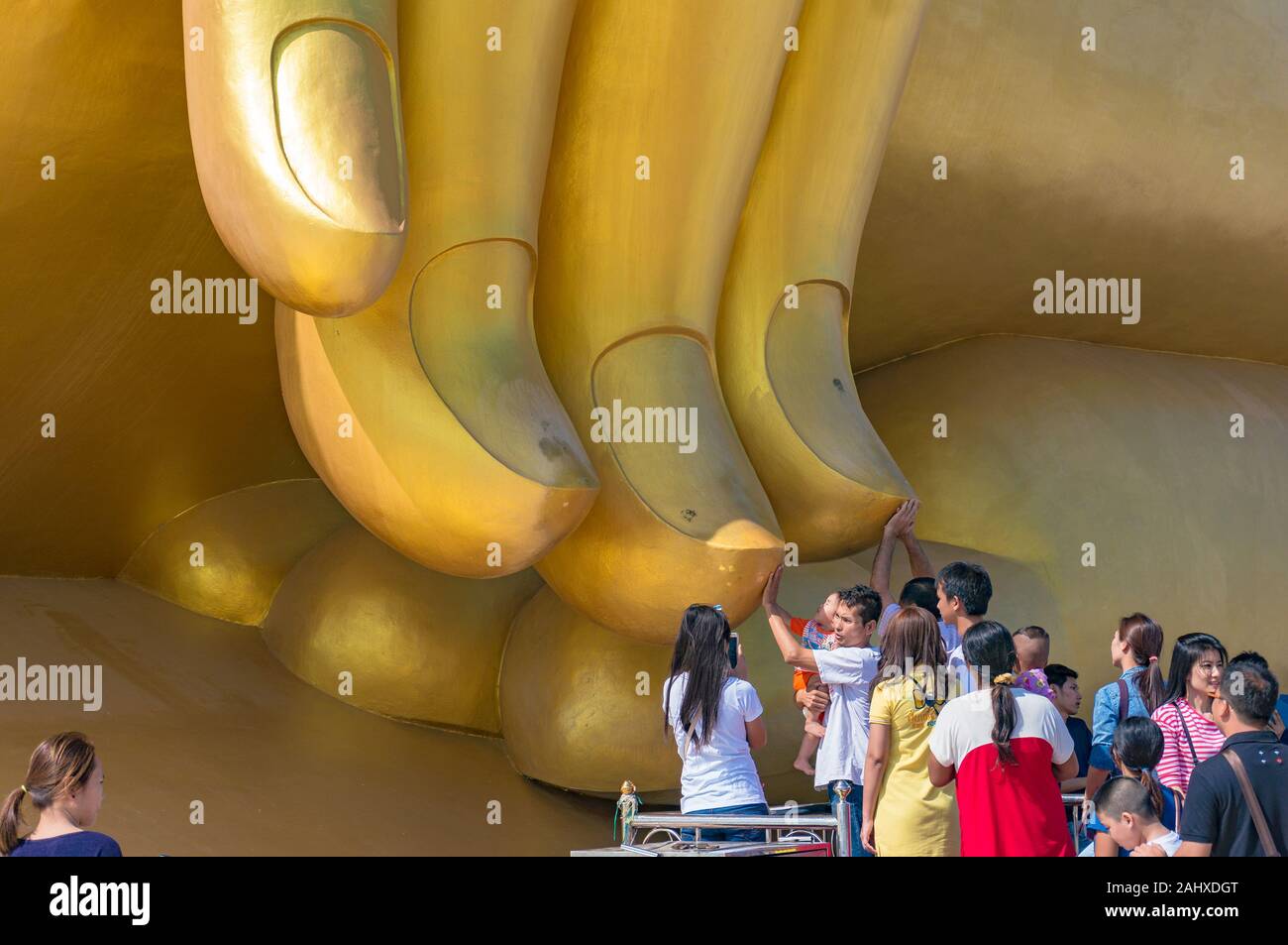 Child touching statue hi-res stock photography and images - Alamy