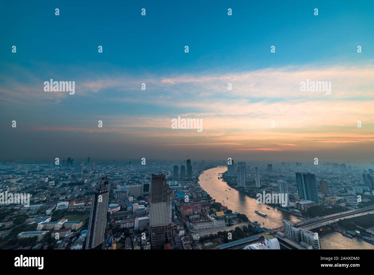 Aerial view of Bangkok cityscape with Chao Phraya river at sunset ...