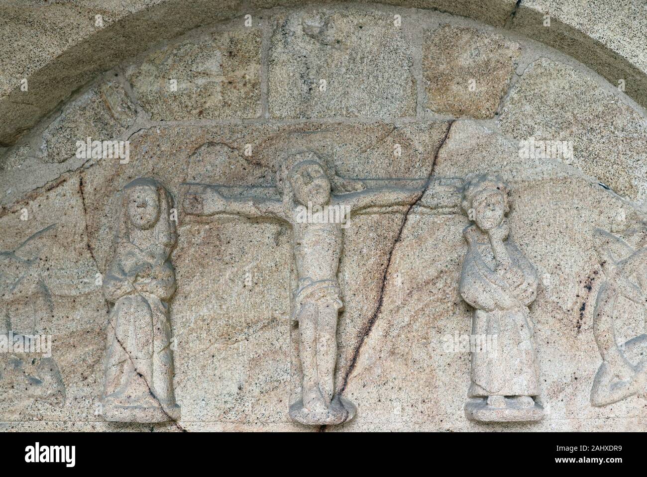 Medieval relief of the Crucifixion above the entrance to Saint-Guigner ...