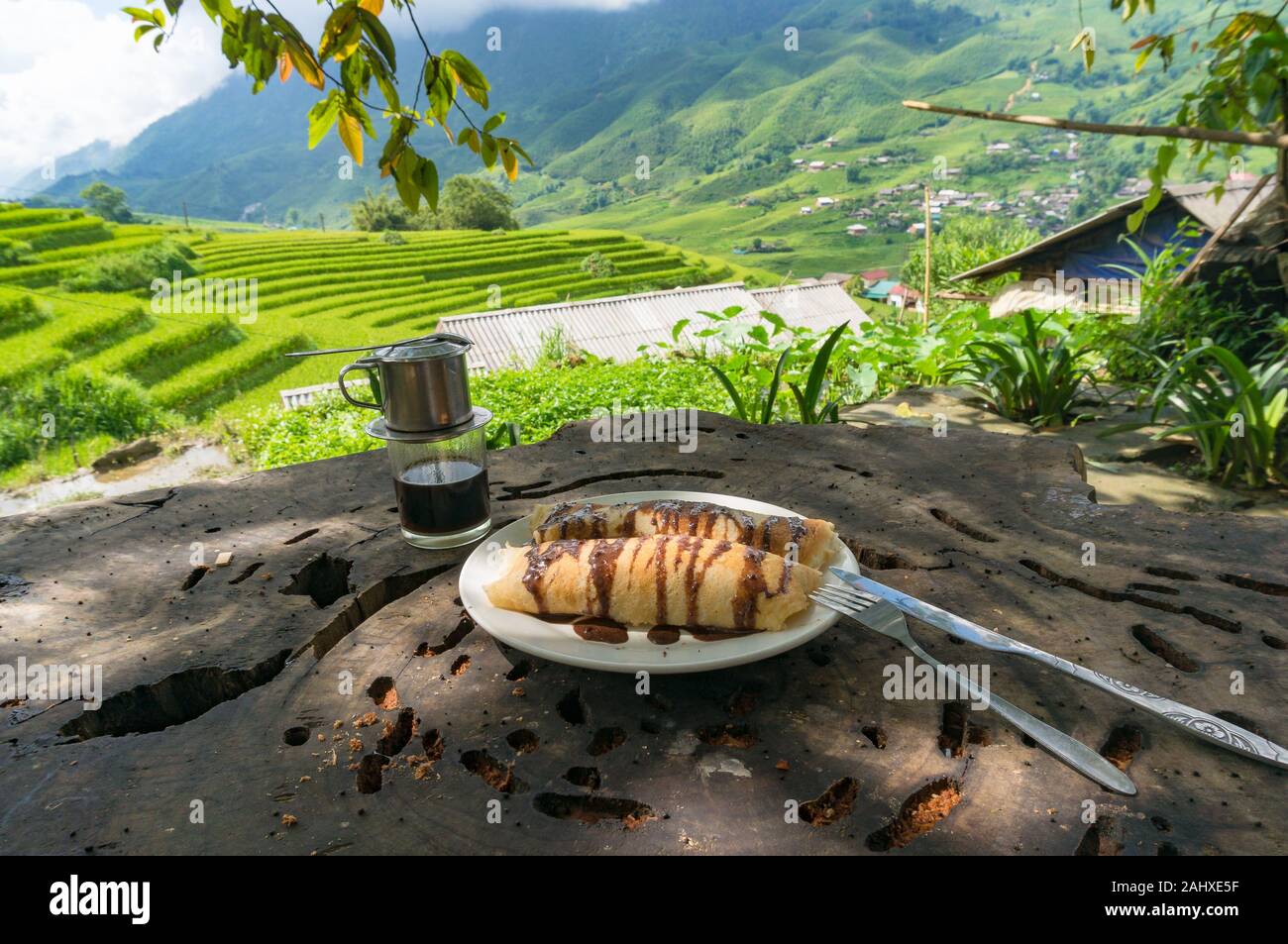 Pancakes and Vietnamese style coffee with picturesque background of ...