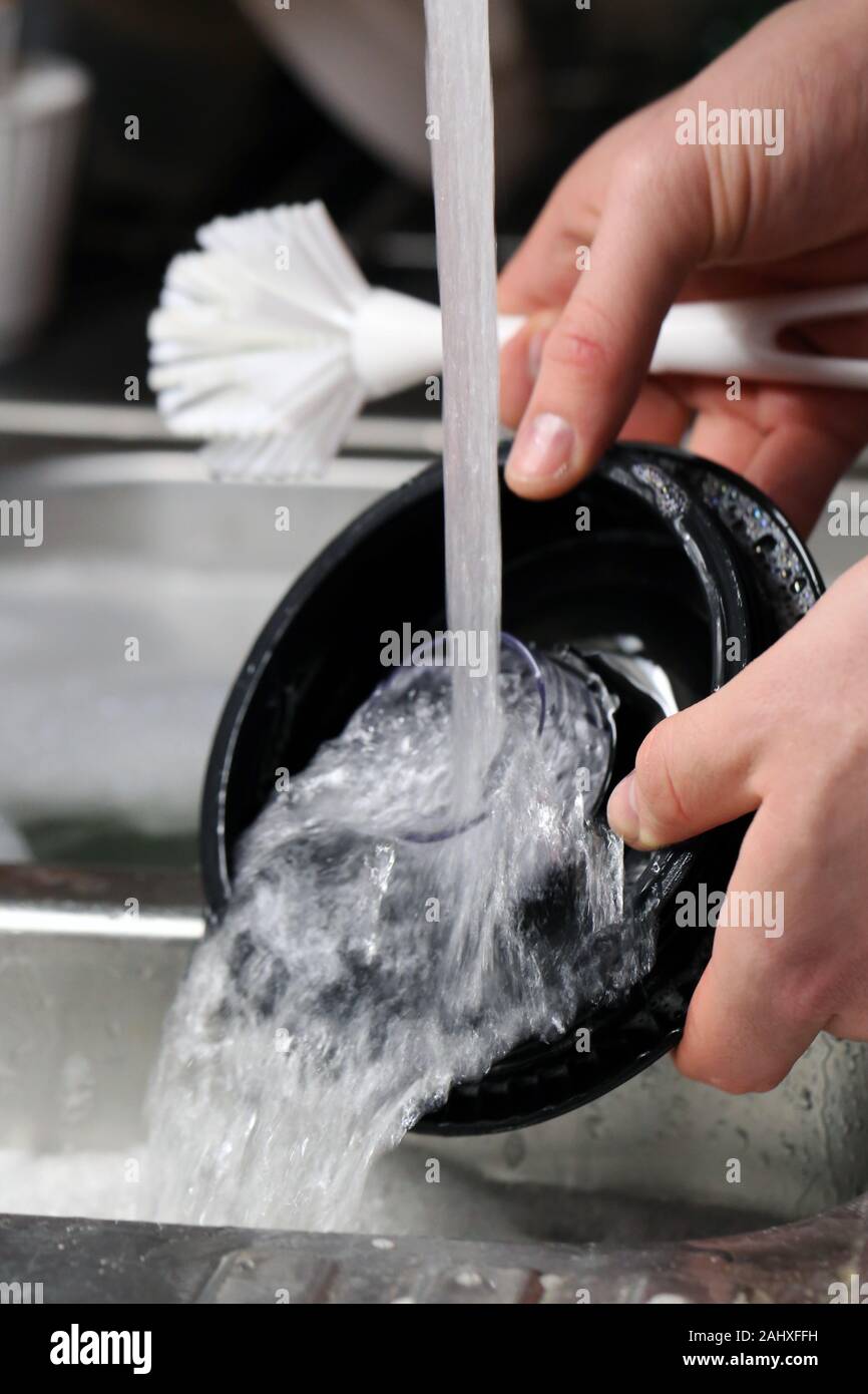 Doing dishes after cooking at home. Caucasian male doing the dishes ...