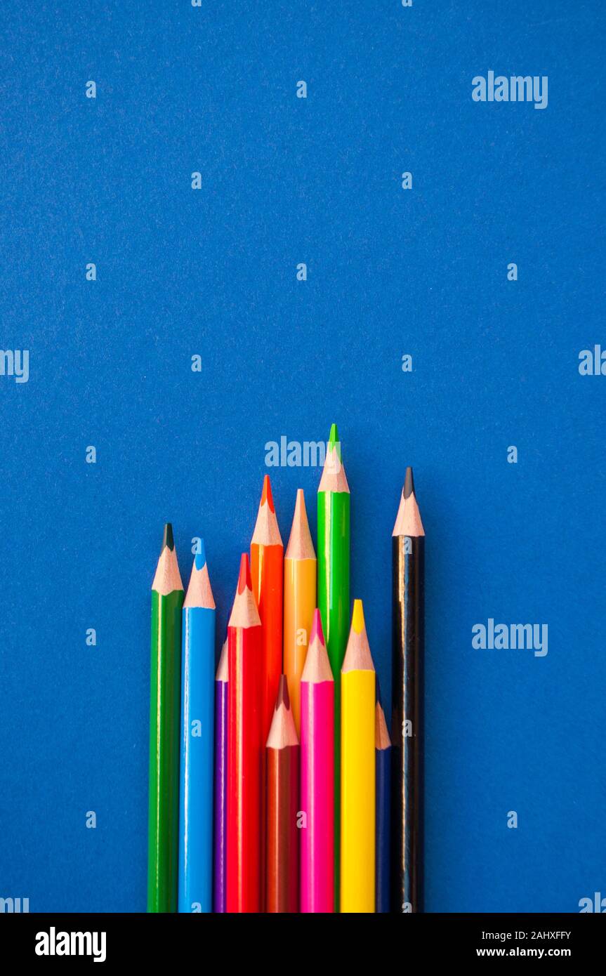 Colorful pencils on blue background with copyspace. 2020 color trend ...