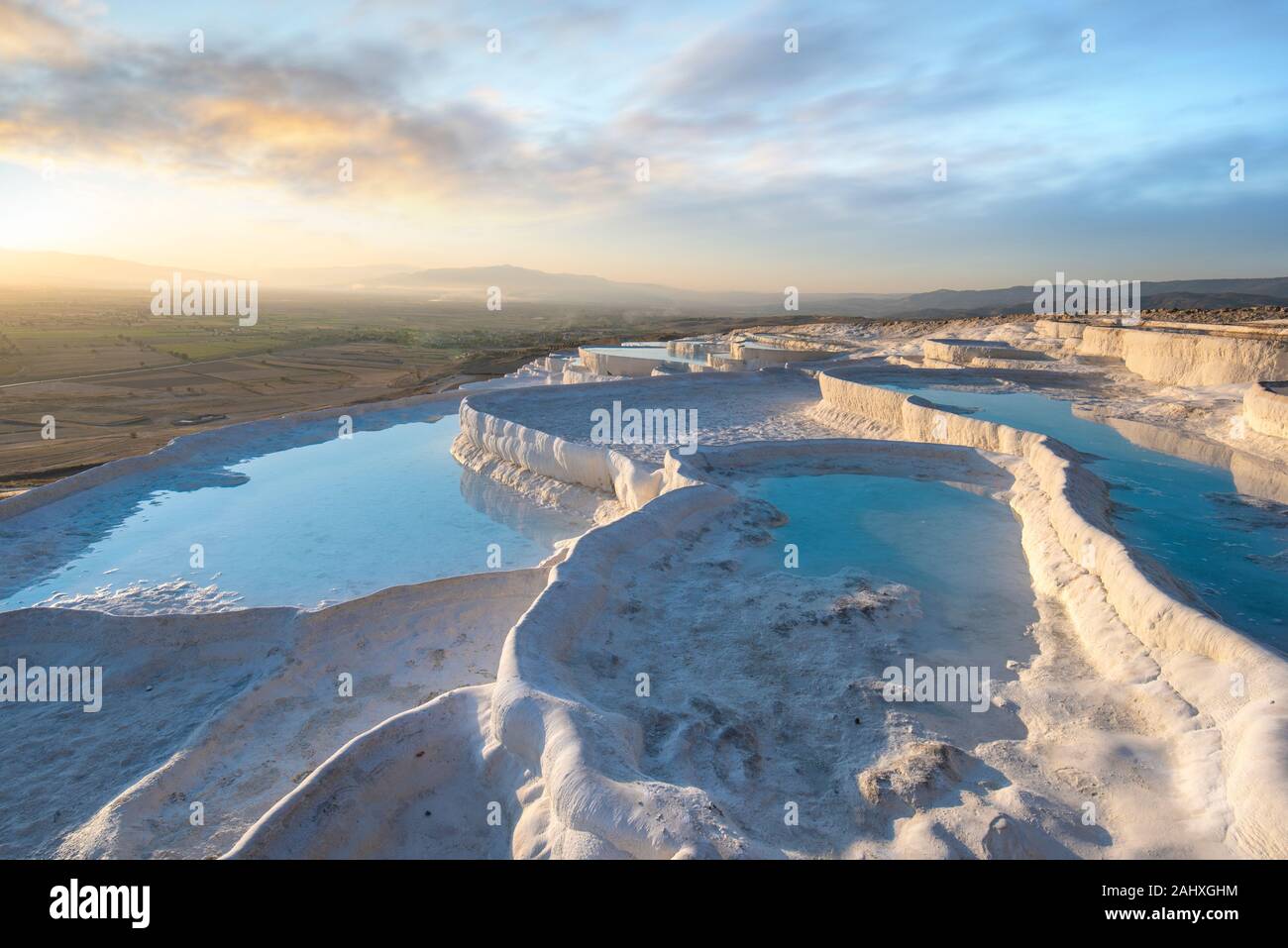 Beautiful sunset and Natural travertine pools and terraces in Pamukkale ...
