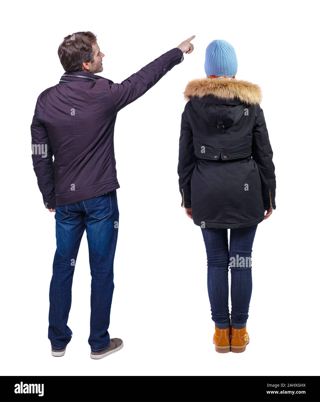Back view of couple couple in winter jackets pointing. beautiful ...