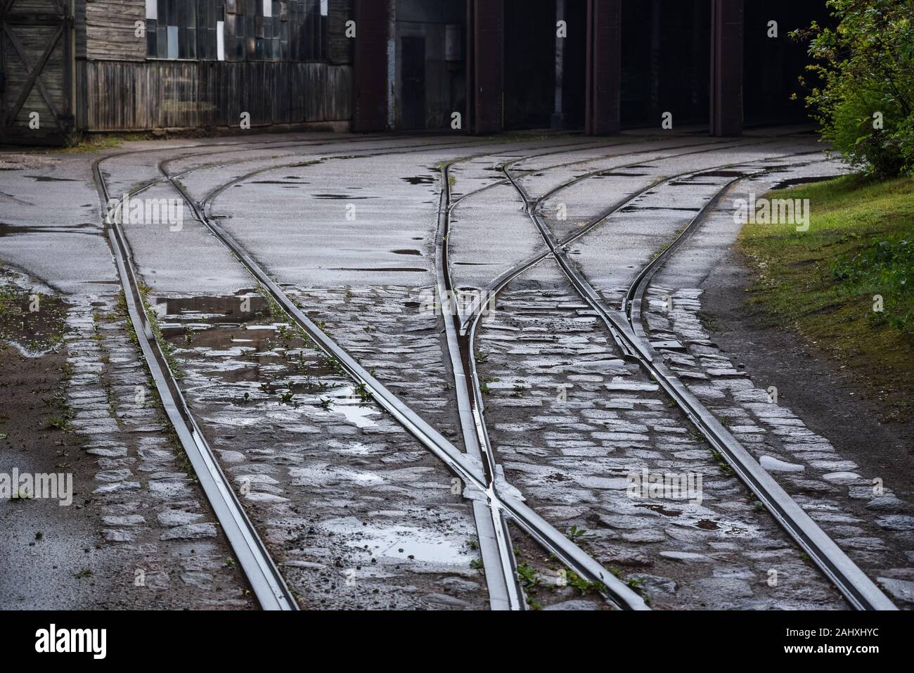 Cross of trams rail road and gates of depot Stock Photo - Alamy