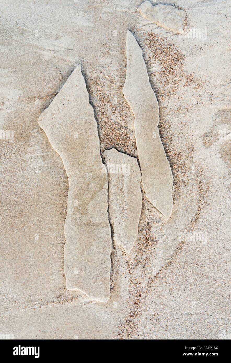 Beach background with broken frosted piece of wet sand Stock Photo - Alamy