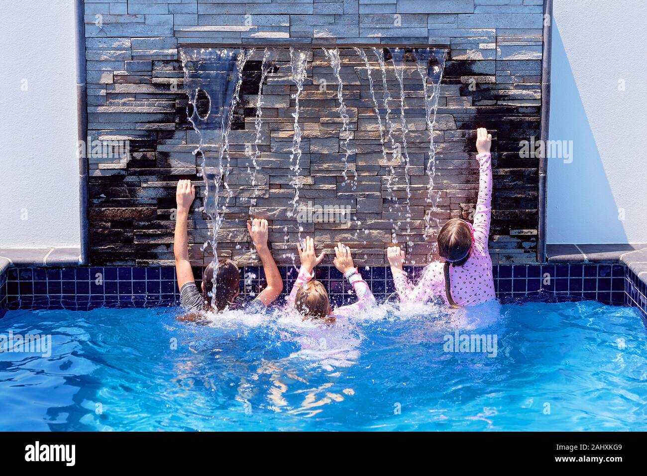 Girl playing in waterfall hi-res stock photography and images - Alamy