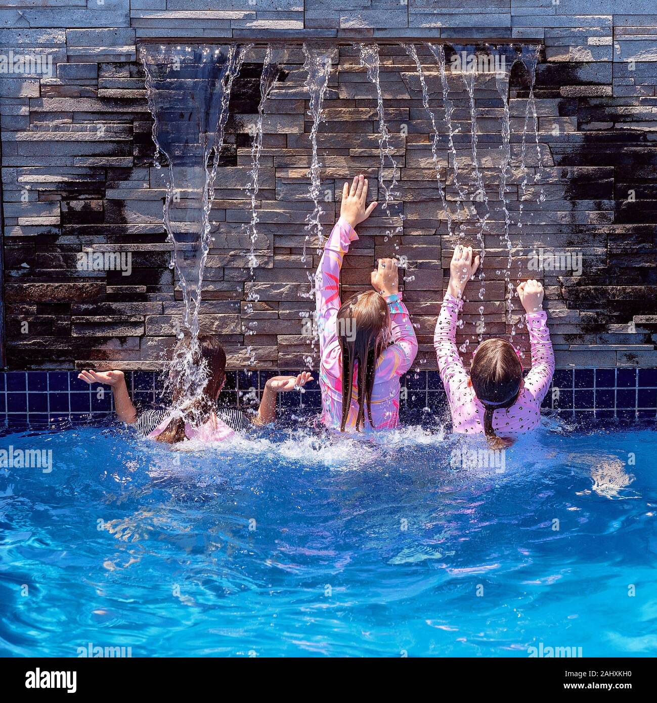 Girl playing in waterfall hi-res stock photography and images - Alamy