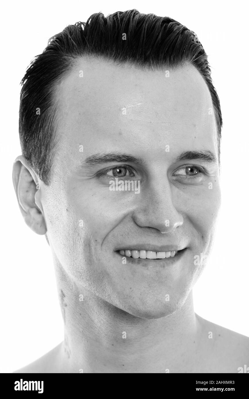 Face of young happy man smiling while thinking Stock Photo - Alamy